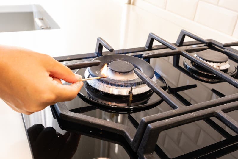 Hand with a Match Ignites a Gas Burner Stock Photo - Image of blue ...