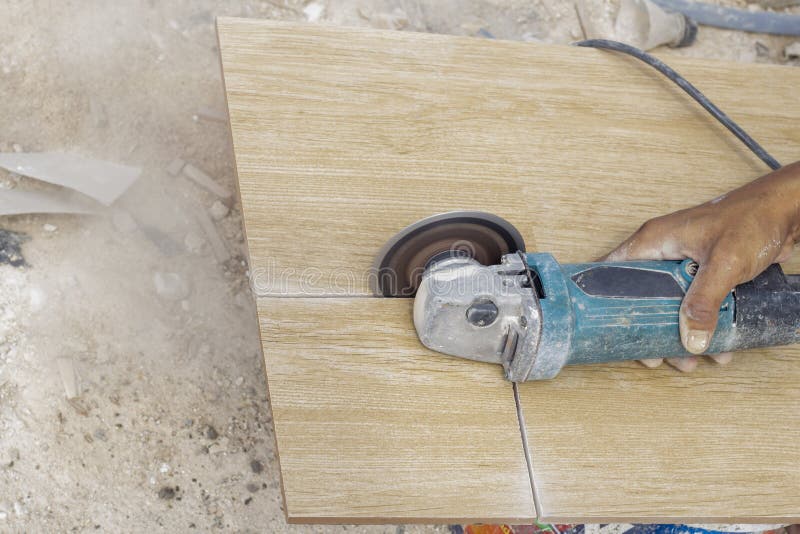 Hand of the Mechanic is Holding Electric Angle Grinder To Cutting a ...