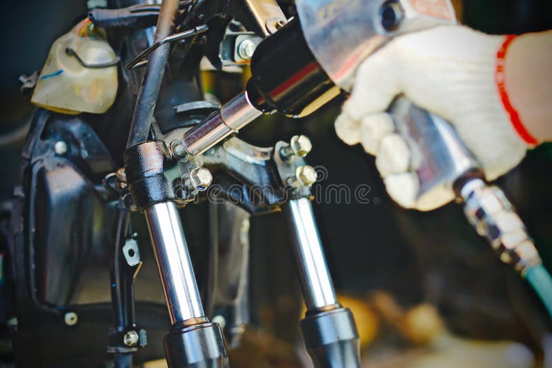 Hand of Mechanic Man Replace and Adjust Motorcycle Rear Brake System ...