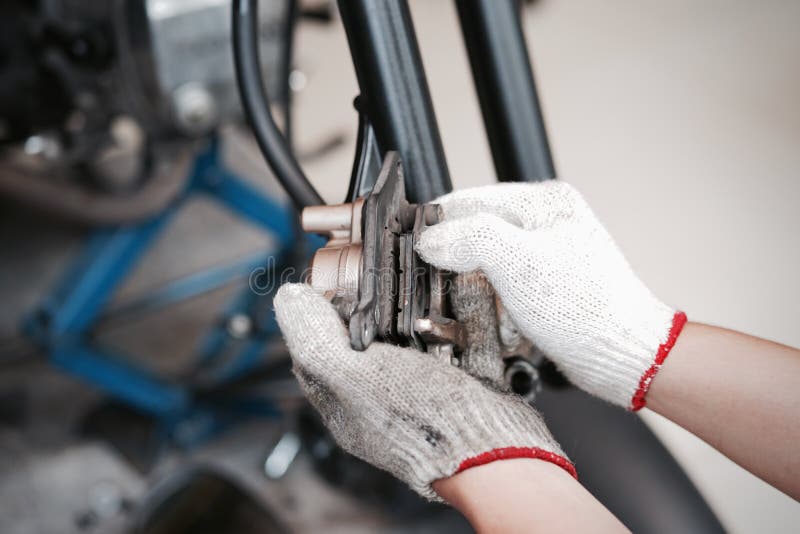 Hand of Mechanic Man Replace and Adjust Motorcycle Rear Brake System ...