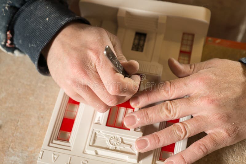 Hand with Metal Object Working on Plaster Scale Model Building Stock ...