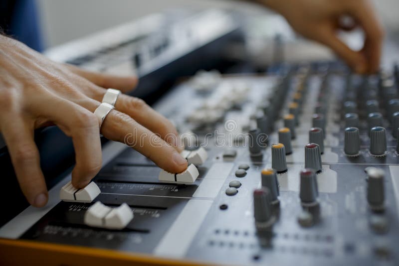 Hand on a Mixer, Operating the Leader. Sound Engineer Working at Mixing ...