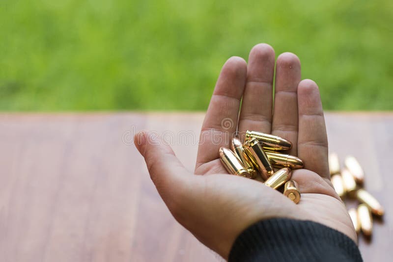 Hand with 9mm Bullets. Hand Holding Bullets Stock Photo - Image of ...