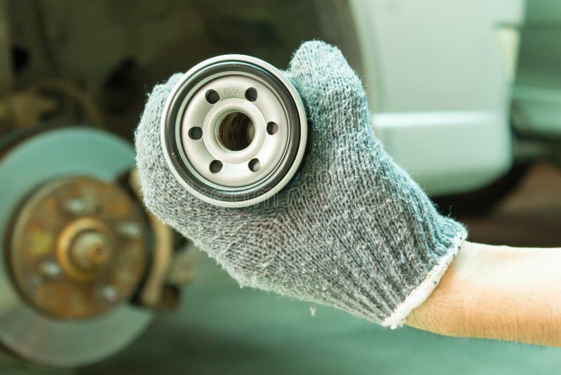 Hand with New oil Filter. stock photo. Image of detail - 190237726