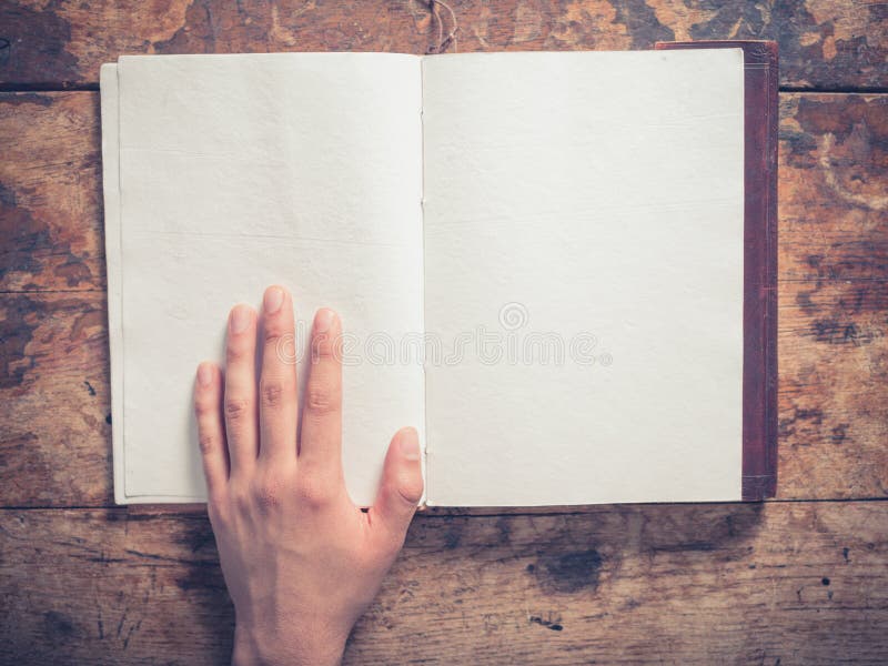 Hand and Notepad on a Wooden Table Stock Photo - Image of empty, wooden ...