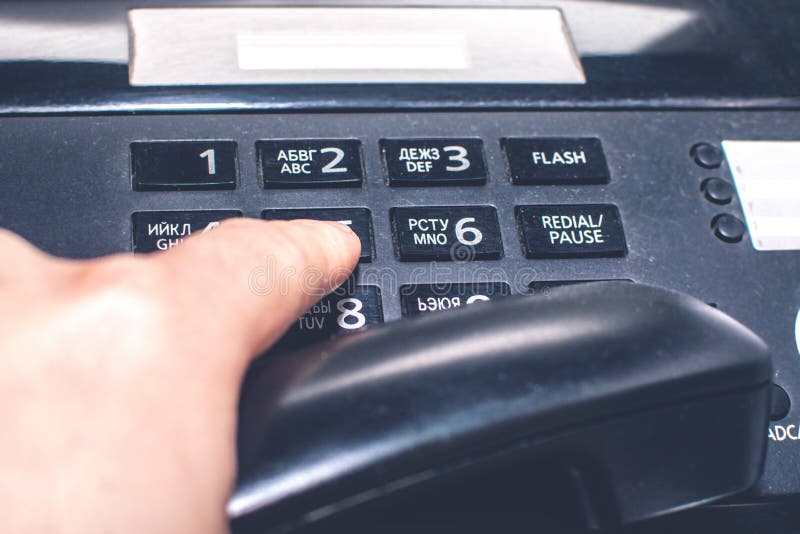 The Hand of an Office Worker Holds the Phone Receiver and Presses the ...
