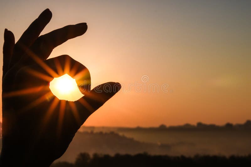 Hand in ok shape with sun stock photo. Image of person - 181157206