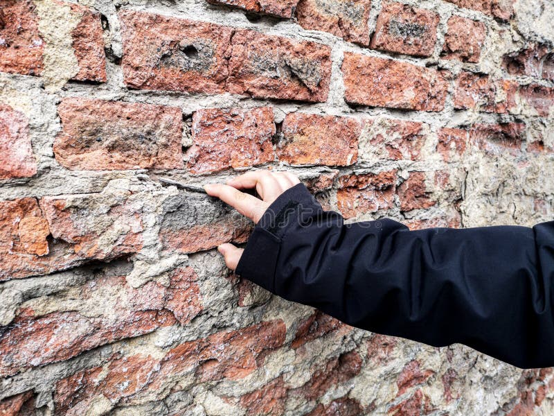 Hand on an old brick wall. stock image. Image of interior - 217449003