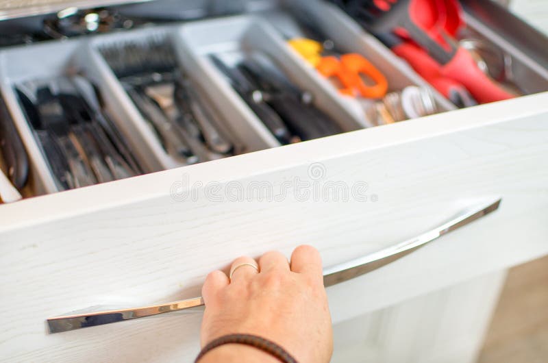Hand open cutlery drawer stock photo. Image of action - 72343144