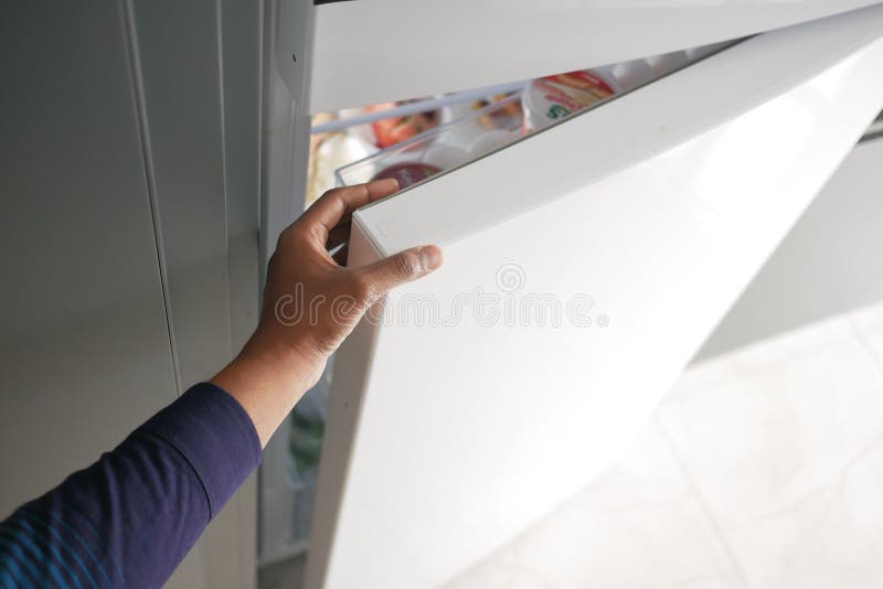 Hand open a fridge door stock image. Image of grocery - 278578949