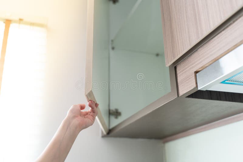 Hand Open Kitchen Cabinet stock image. Image of modern - 135145815