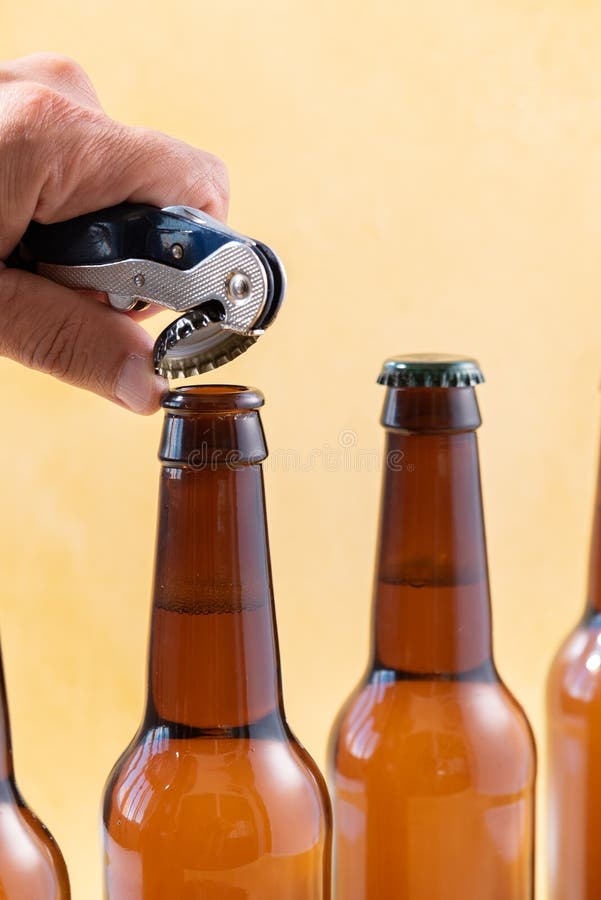 Hand Opening Beer Bottle with Blurred Background Stock Image - Image of ...