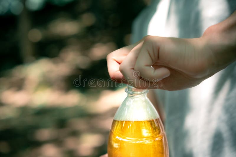 Hand Opening a Bottle of Draft Beer Stock Image - Image of counter ...