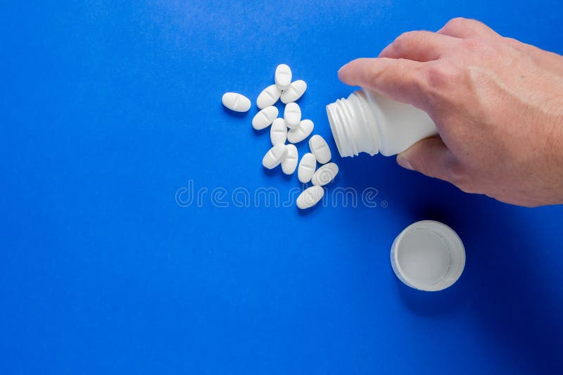 Hand Pouring White Pills on the Table Stock Image - Image of container ...