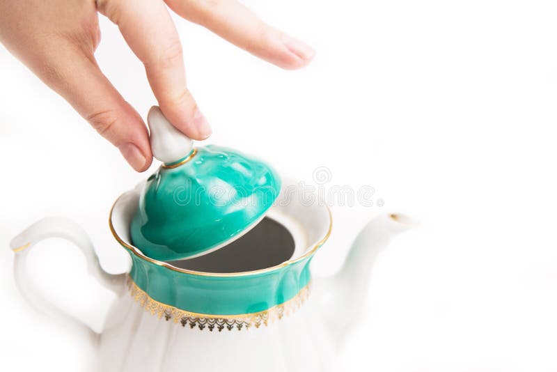 Hand Opening Cap of Kettle with Tea on White Background Stock Photo ...
