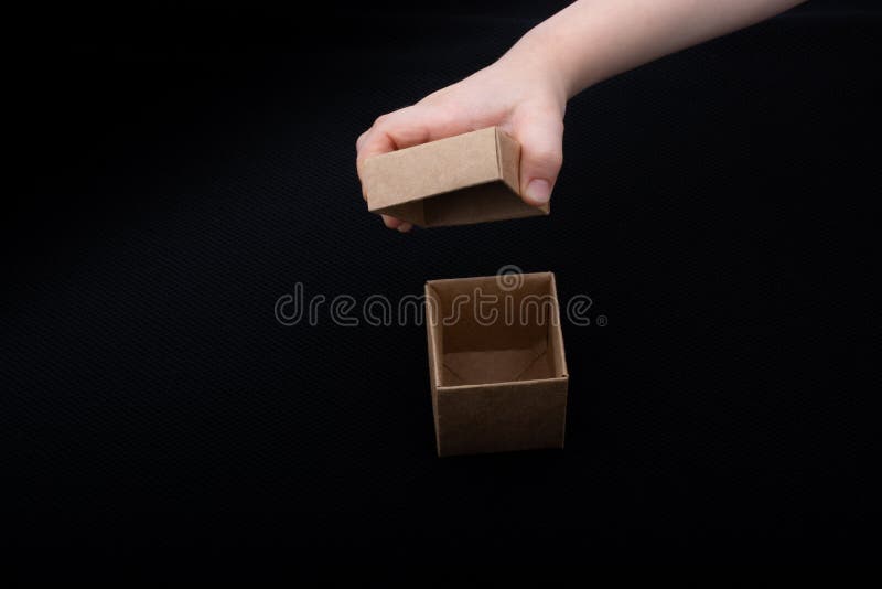 Hand Opening Cardboard Box on a Black Background Stock Image - Image of ...