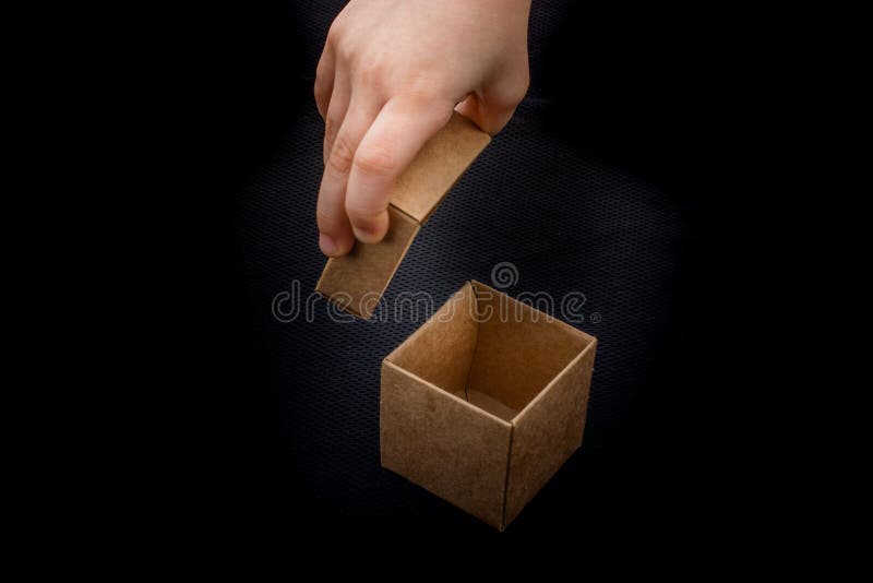 Hand Opening Cardboard Box on a Black Background Stock Image - Image of ...