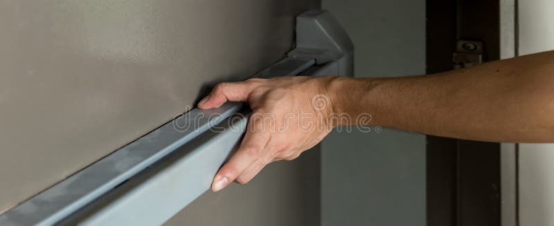 Hand is Opening the Emergency Fire Exit Door. Emergency Fire Exit Door ...