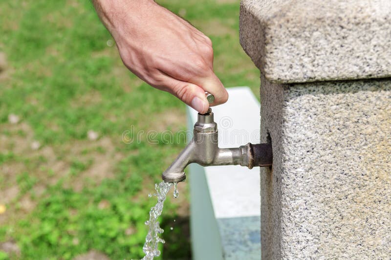 Hand Opening Water Drip from Water Tap in Park Stock Image - Image of ...