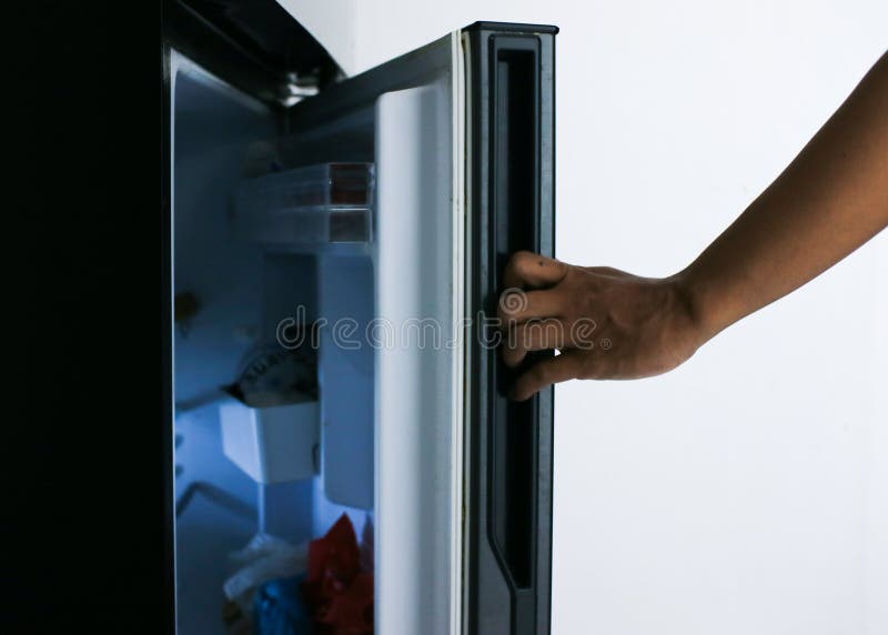 A Hand Opens the Fridge Door, Revealing a Glimpse into daily Life and ...