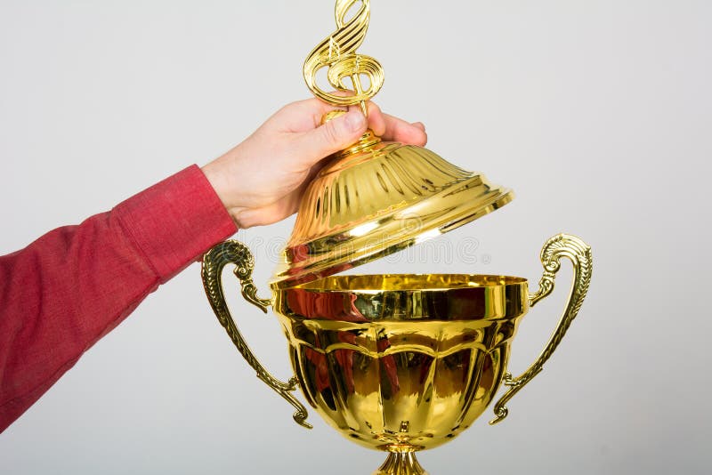 Hand opens lid of gold cup stock image. Image of plinth - 54243505