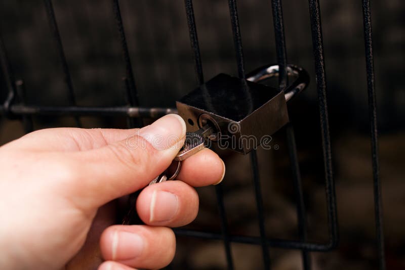 Hand Opens the Lock on the Grate Stock Photo - Image of finger, door ...