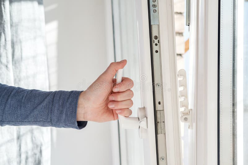 Hand Opens a PVC Window, Holding the Handle in an Upright Position ...