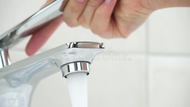 The Hand Opens the Water Tap in Close-up. Fresh Water Reserves in ...