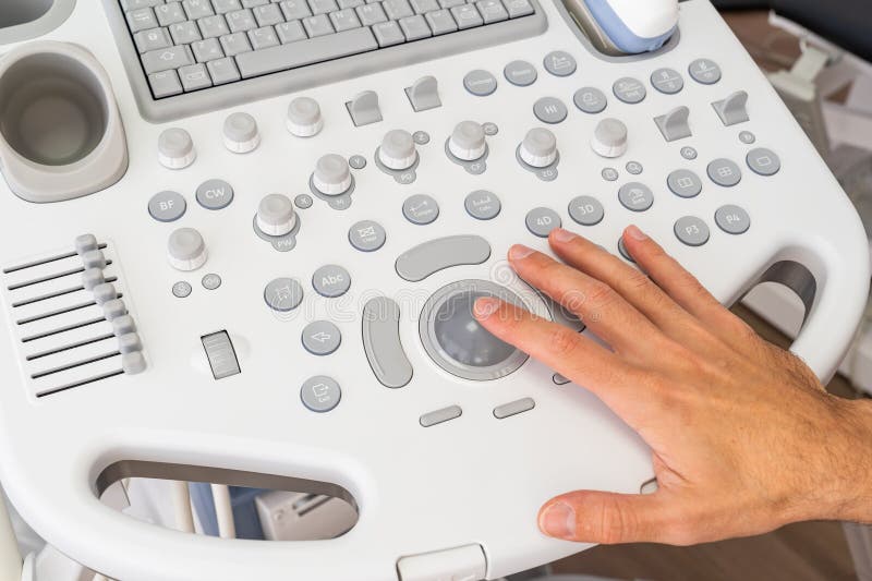 Hand Operating Ultrasound Machine Control Panel in a Medical Setting ...