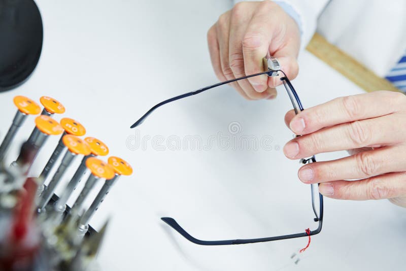 Hand of Optician Fixing Glasses Stock Photo - Image of metal, hand ...