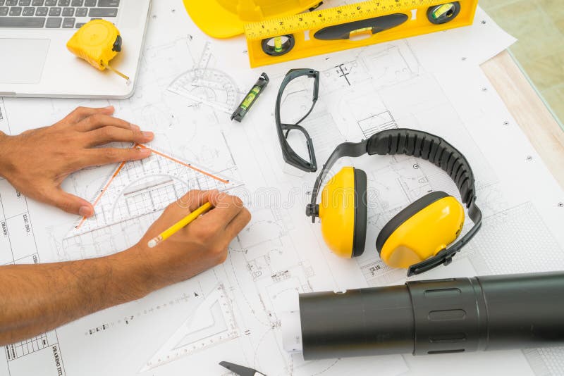 Hand Over Construction Plans with Yellow Helmet and Drawing Tool Stock ...