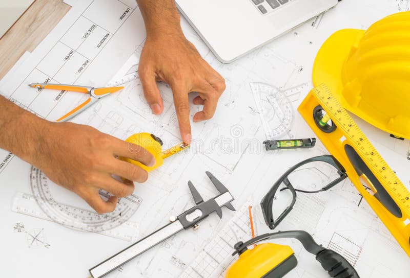Hand Over Construction Plans with Yellow Helmet and Drawing Tool Stock ...