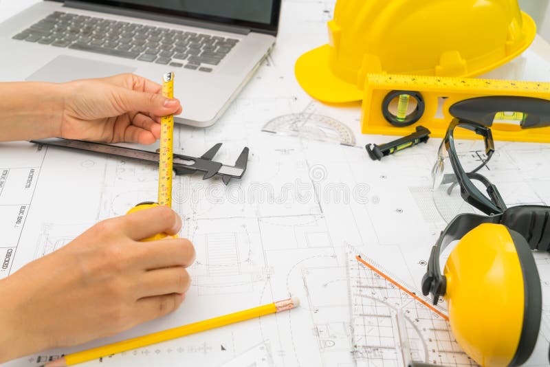 Hand Over Construction Plans with Yellow Helmet and Drawing Tool Stock ...