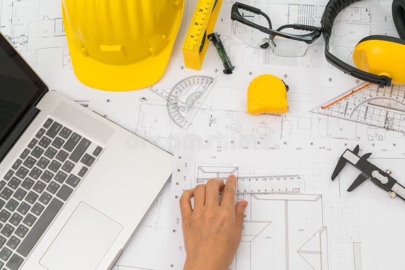 Hand Over Construction Plans with Yellow Helmet and Drawing Tool Stock ...