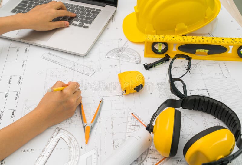 Hand Over Construction Plans with Yellow Helmet and Drawing Tool Stock ...