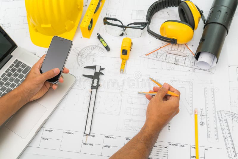 Hand Over Construction Plans with Yellow Helmet and Drawing Tool Stock ...