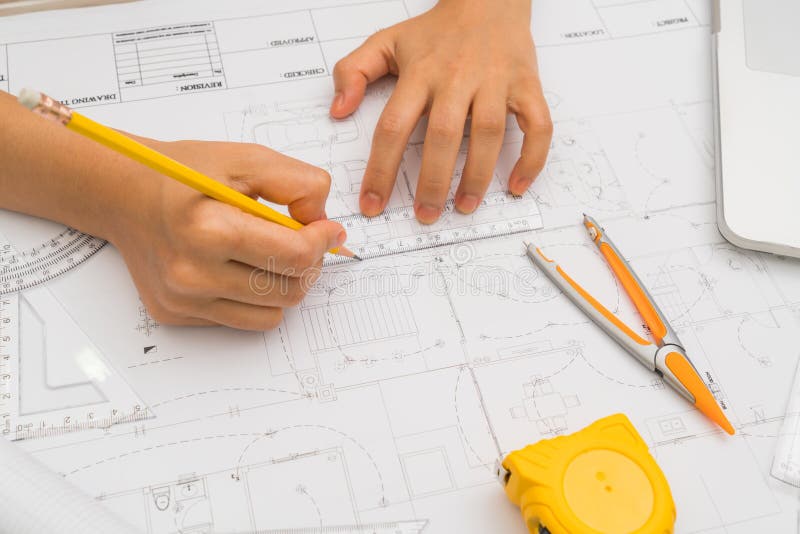 Hand Over Construction Plans with Yellow Helmet and Drawing Tool Stock ...