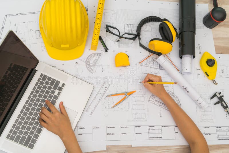 Hand Over Construction Plans with Yellow Helmet and Drawing Tool Stock ...