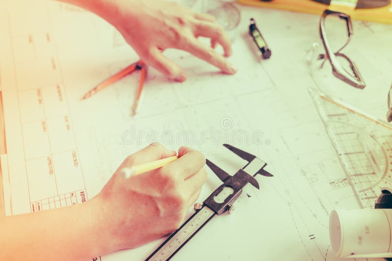 Hand Over Construction Plans with Yellow Helmet and Drawing Tool Stock ...