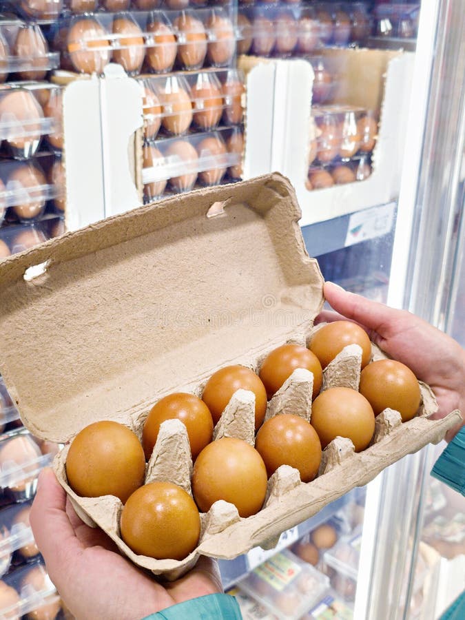 Hand with Packages of Eggs in Store Stock Image - Image of brown ...