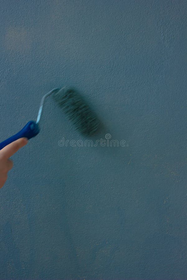 Hand with Paint Roller Over the Blue Wall. Stock Image - Image of ...