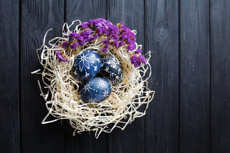 Hand Painted Dark Blue Easter Eggs in Nest and Flowers Stock Photo ...