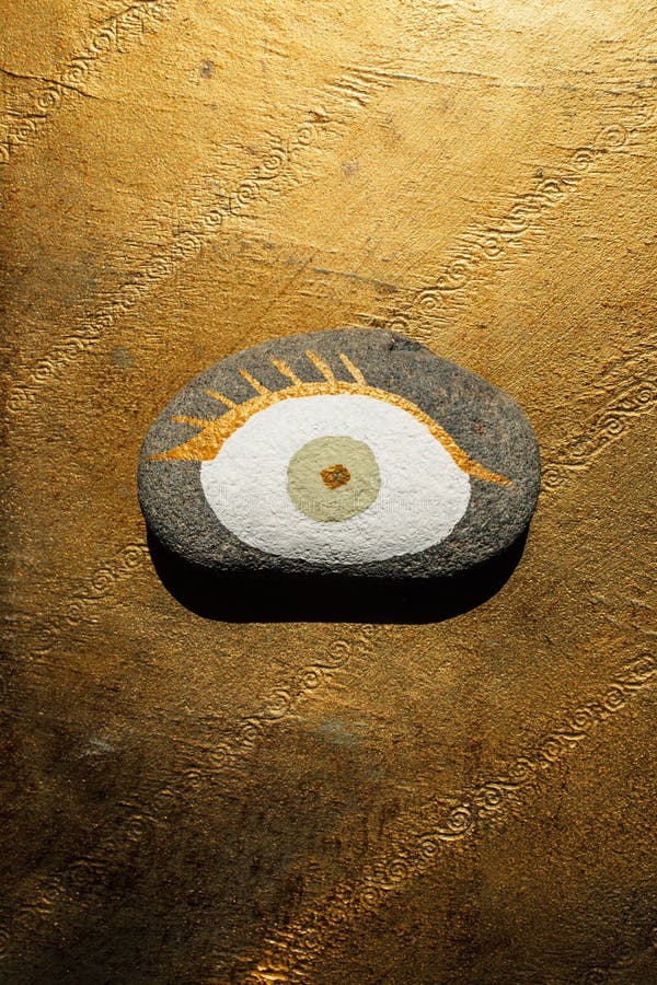 Painted Eye Rock on a Golden Background Stock Image - Image of painted ...