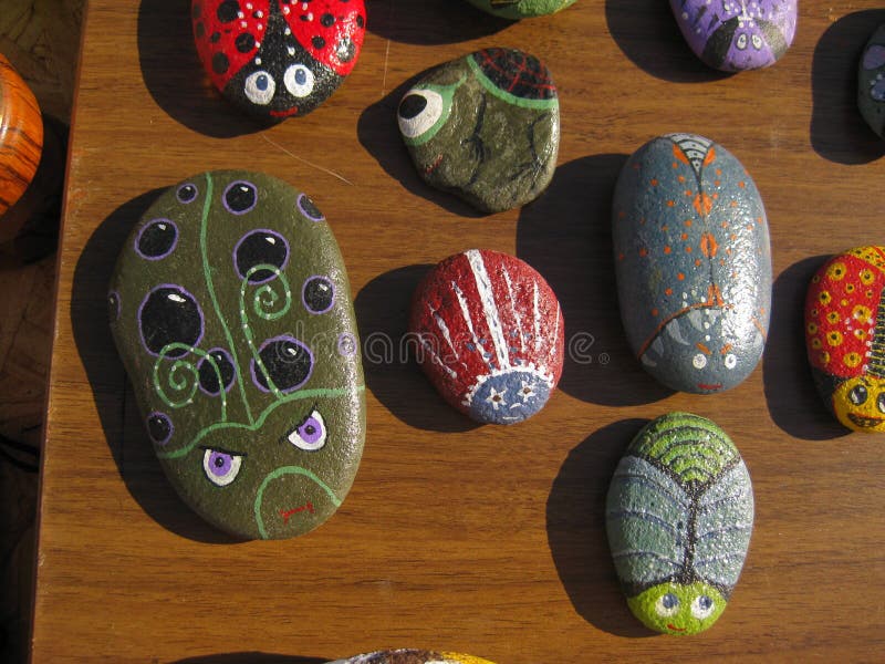 Painted Bug Rocks on Table stock image. Image of look - 256325737