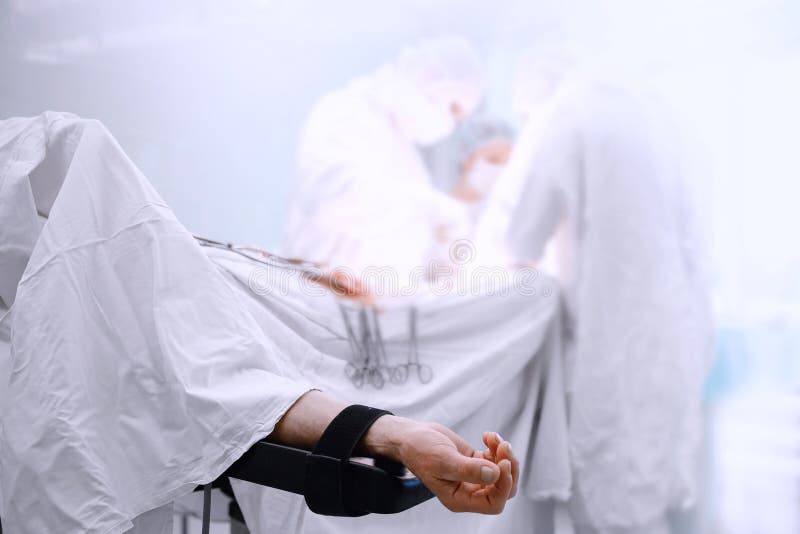 Hand of Patient on Operating Table, Doctors are Operation Person. Light ...