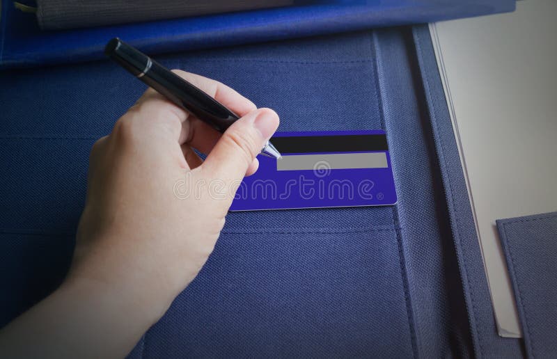 Hand with Pen Sign or Writing Down at the Back of Credit Card Stock ...