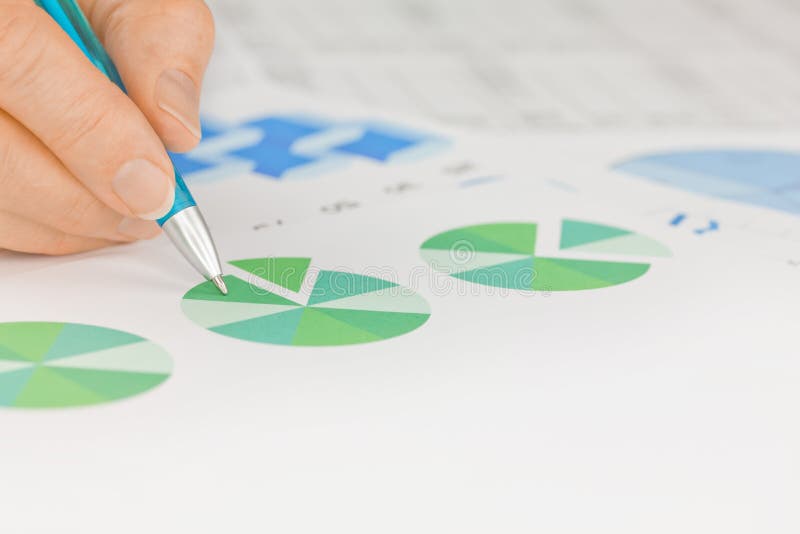 Hand with Pen Working on Graphs and Pie Chart Stock Photo - Image of ...