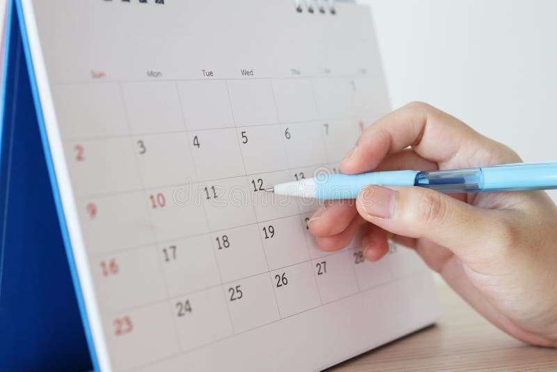 Hand with Pen Writing on Calendar Date Stock Image - Image of annual ...