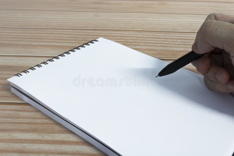 Hand with Pen Writing Notebook on Office Desk Table with. Copy Space ...