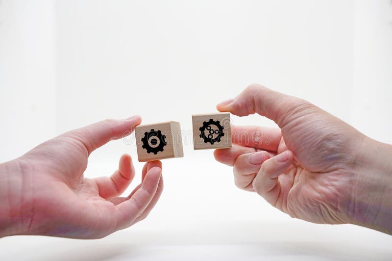 Hand of People Hold Gear Cog Sign on Wood Cube for Team Support Concept ...
